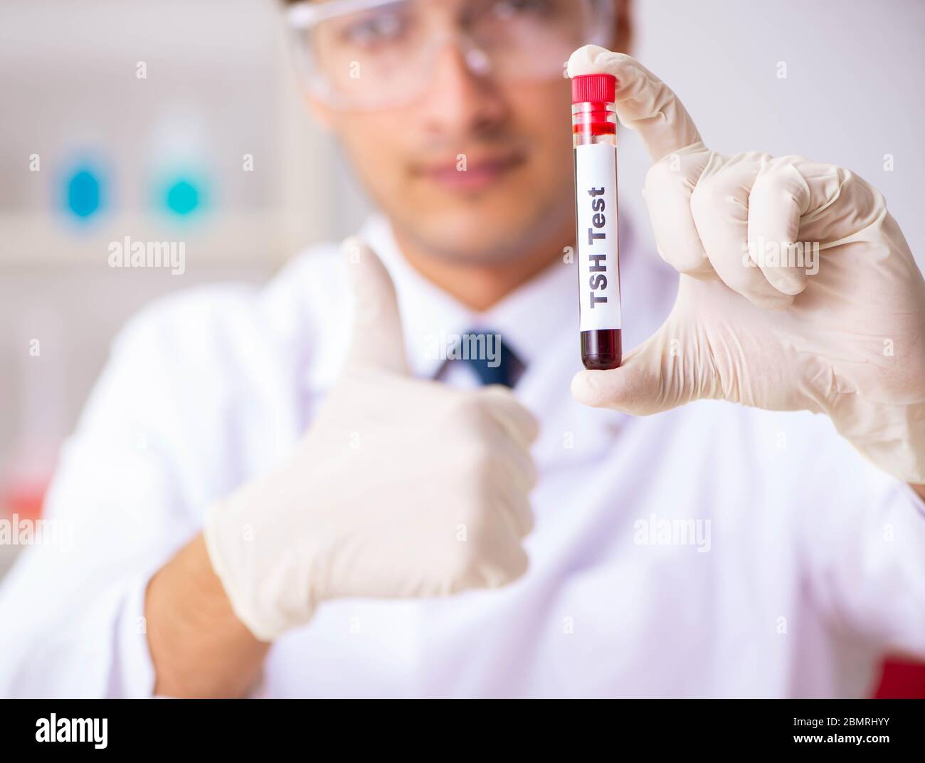 The young handsome lab assistant testing blood samples in hospital ...