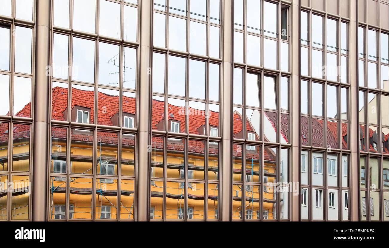 Old building architecture reflected in modern building. Front view of ...