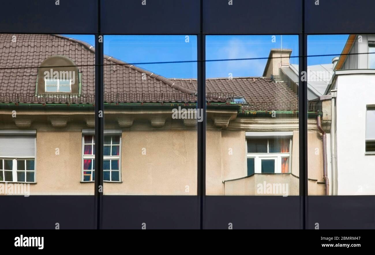 Old building architecture reflected in modern building. Front view of ...
