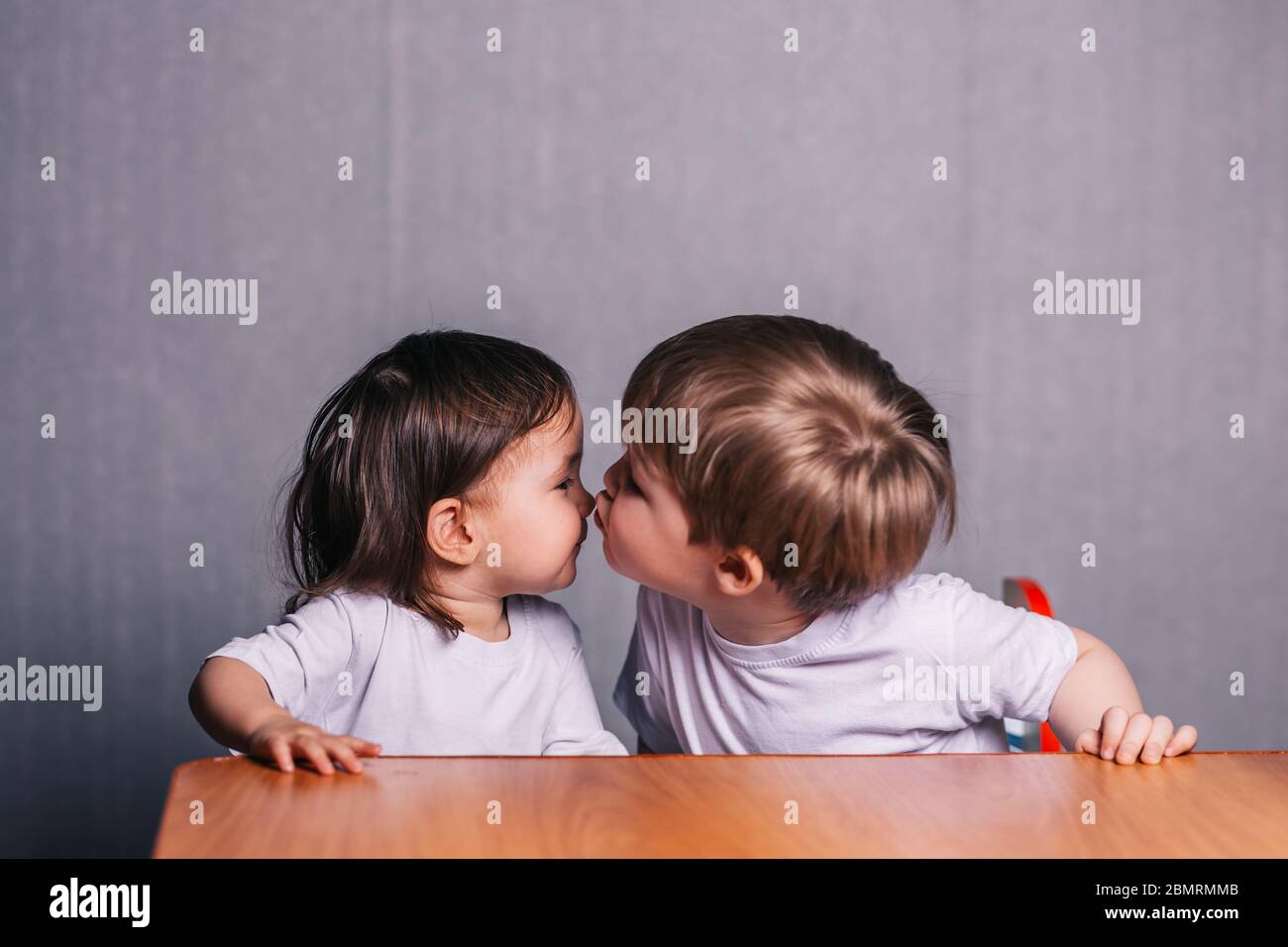 Little boy kisses little girl Stock Photo - Alamy