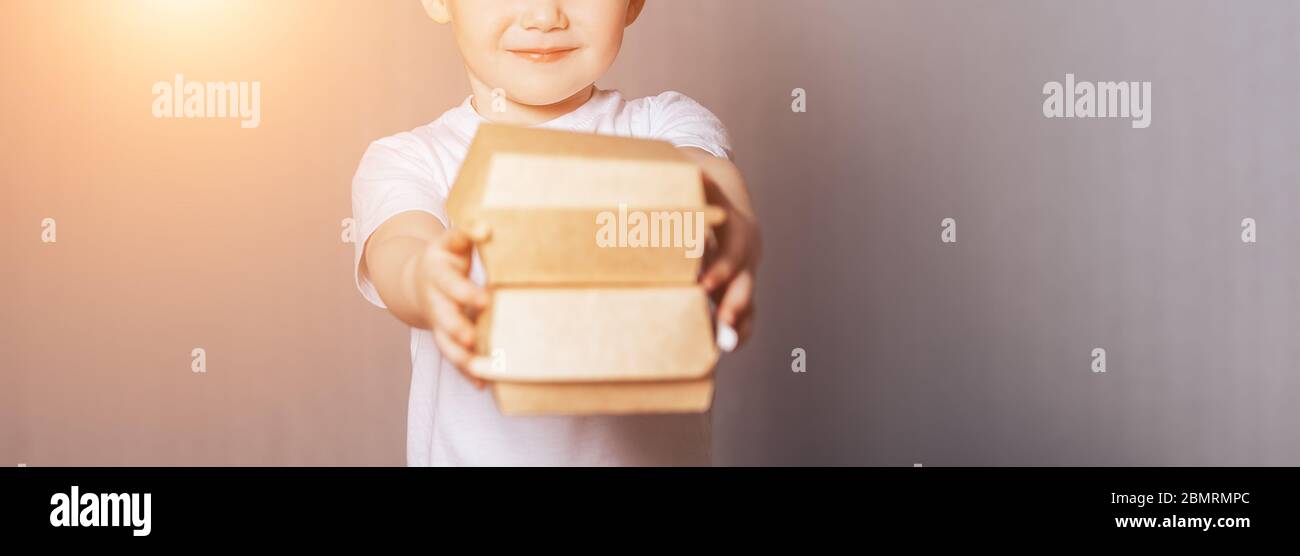 Beautiful little boy holding boxes in hands Stock Photo - Alamy