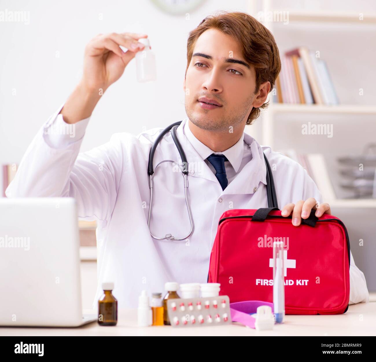 The young doctor with first aid kit in hospital Stock Photo - Alamy