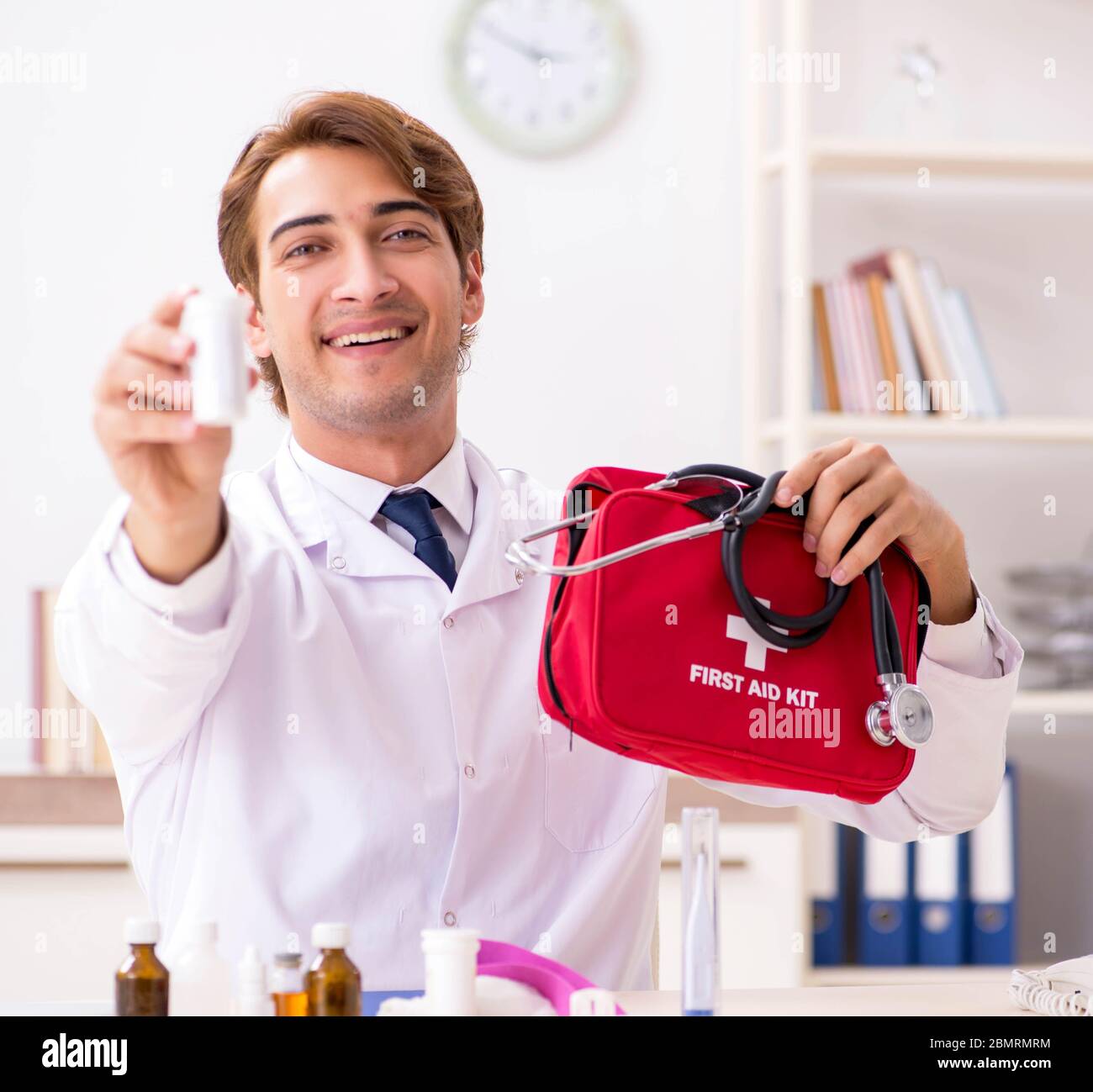 The young doctor with first aid kit in hospital Stock Photo - Alamy