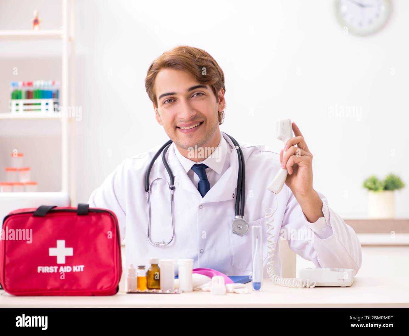 The young doctor with first aid kit in hospital Stock Photo - Alamy