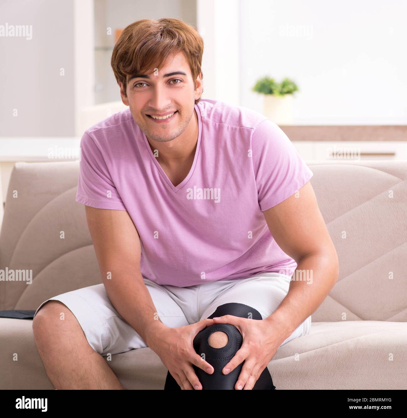 The injured man recovering at home from sports injury Stock Photo - Alamy