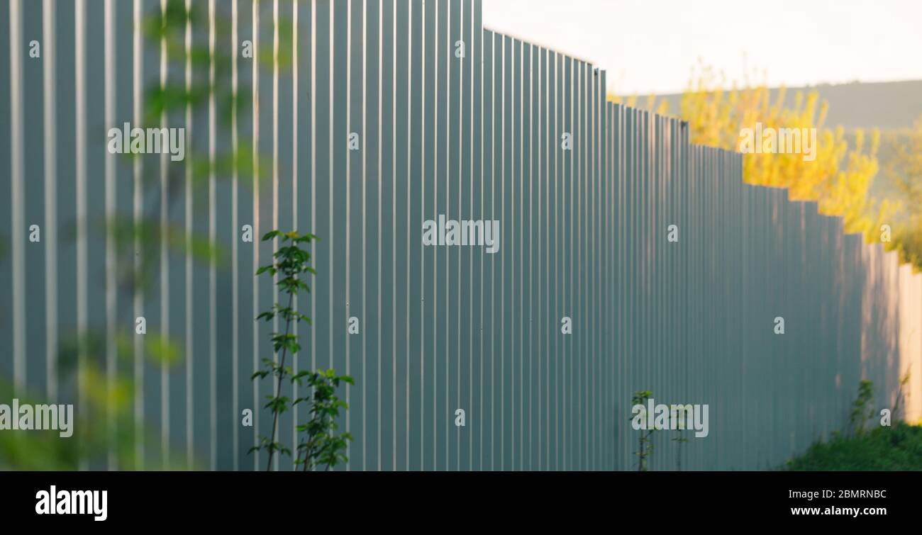 Metal gray fence made of profiled sheet, full insulation from the ...