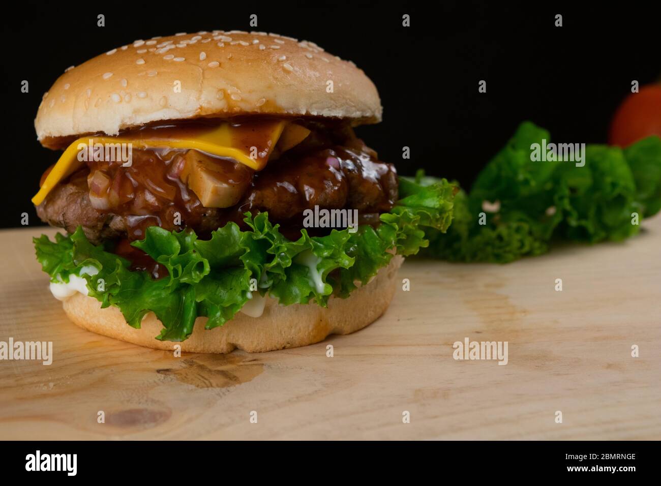 Delicious Grilled Hamburger With Lettuce Leaf on Wooden Table and Dark ...