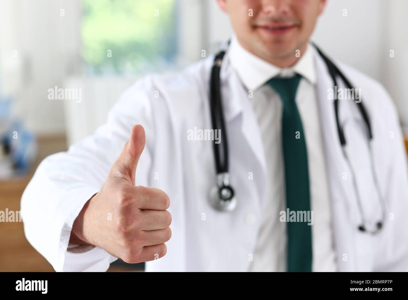 Smiling male medicine doctor showing OK sign with thumb up Stock Photo ...