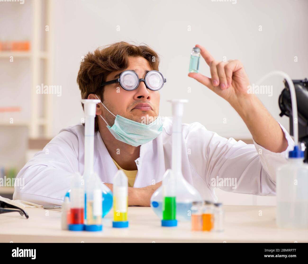 The funny crazy chemist doing experiments and tests Stock Photo - Alamy