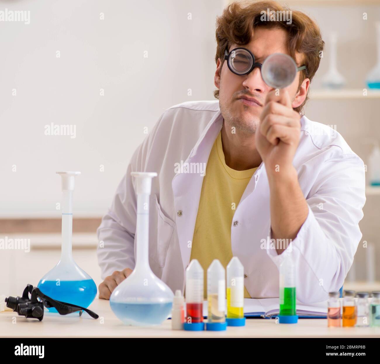 The funny crazy chemist doing experiments and tests Stock Photo - Alamy