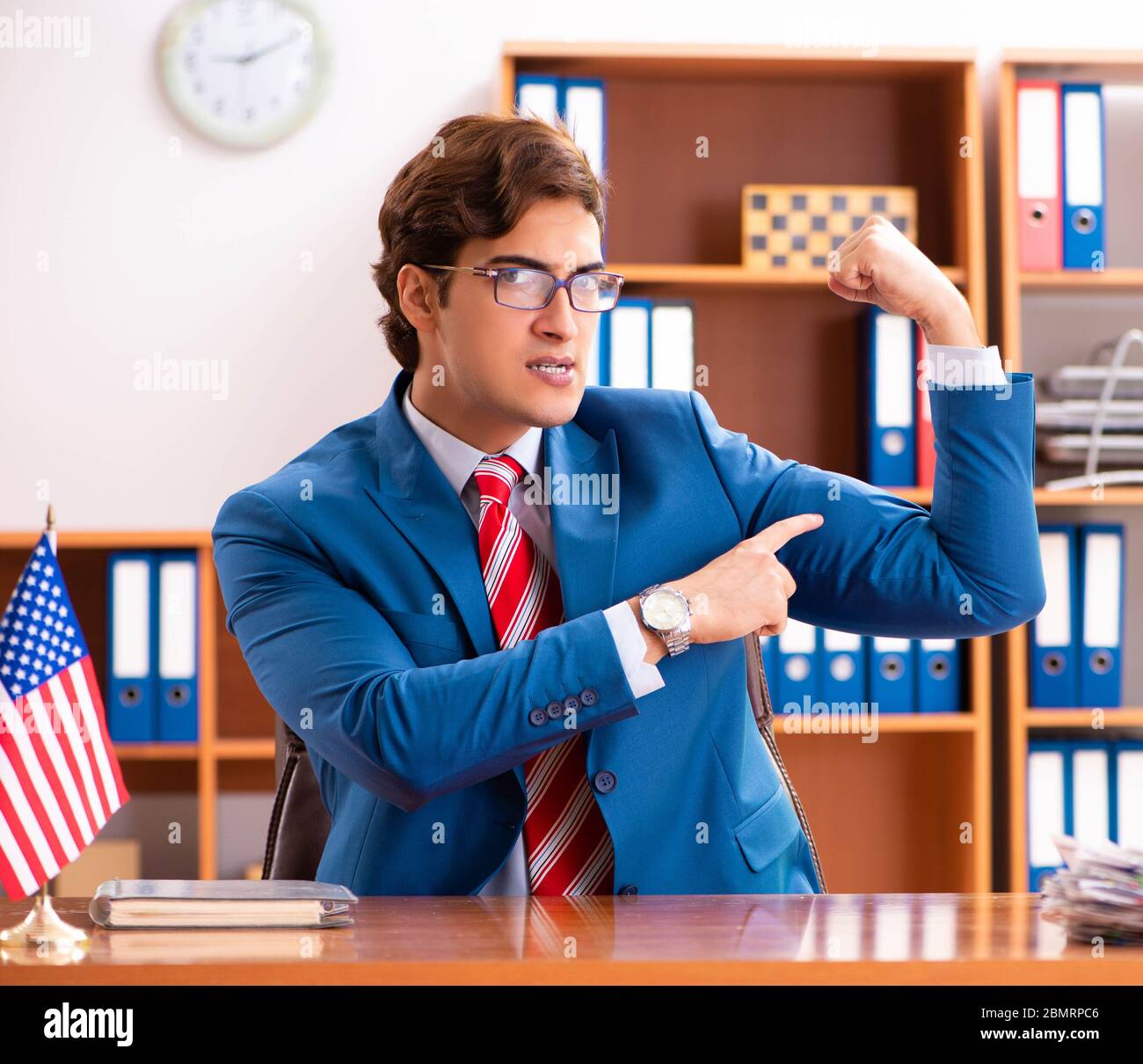 The young handsome politician sitting in office Stock Photo - Alamy