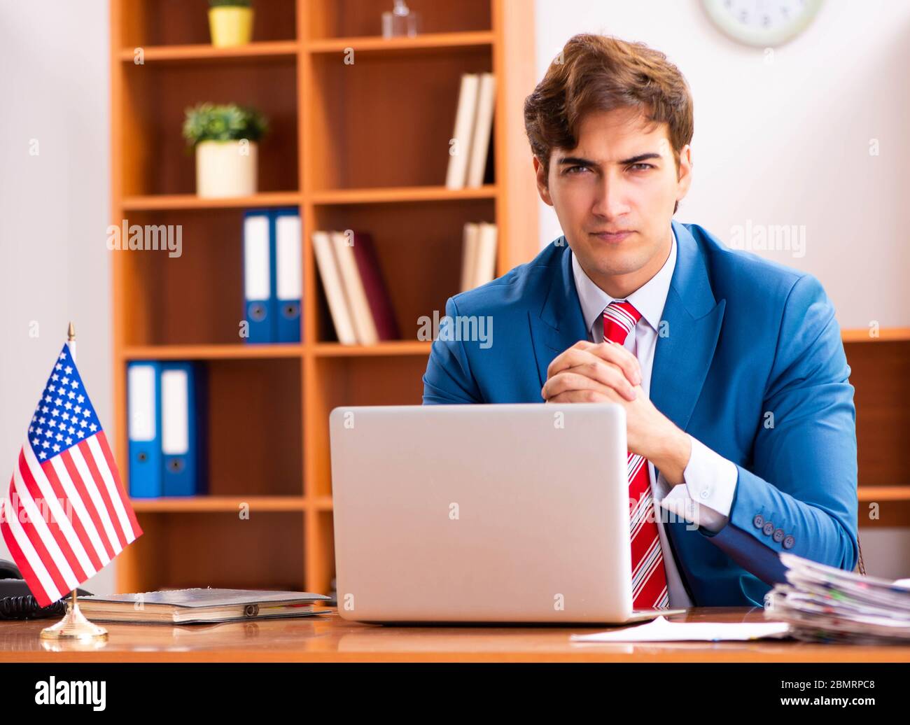 The young handsome politician sitting in office Stock Photo - Alamy