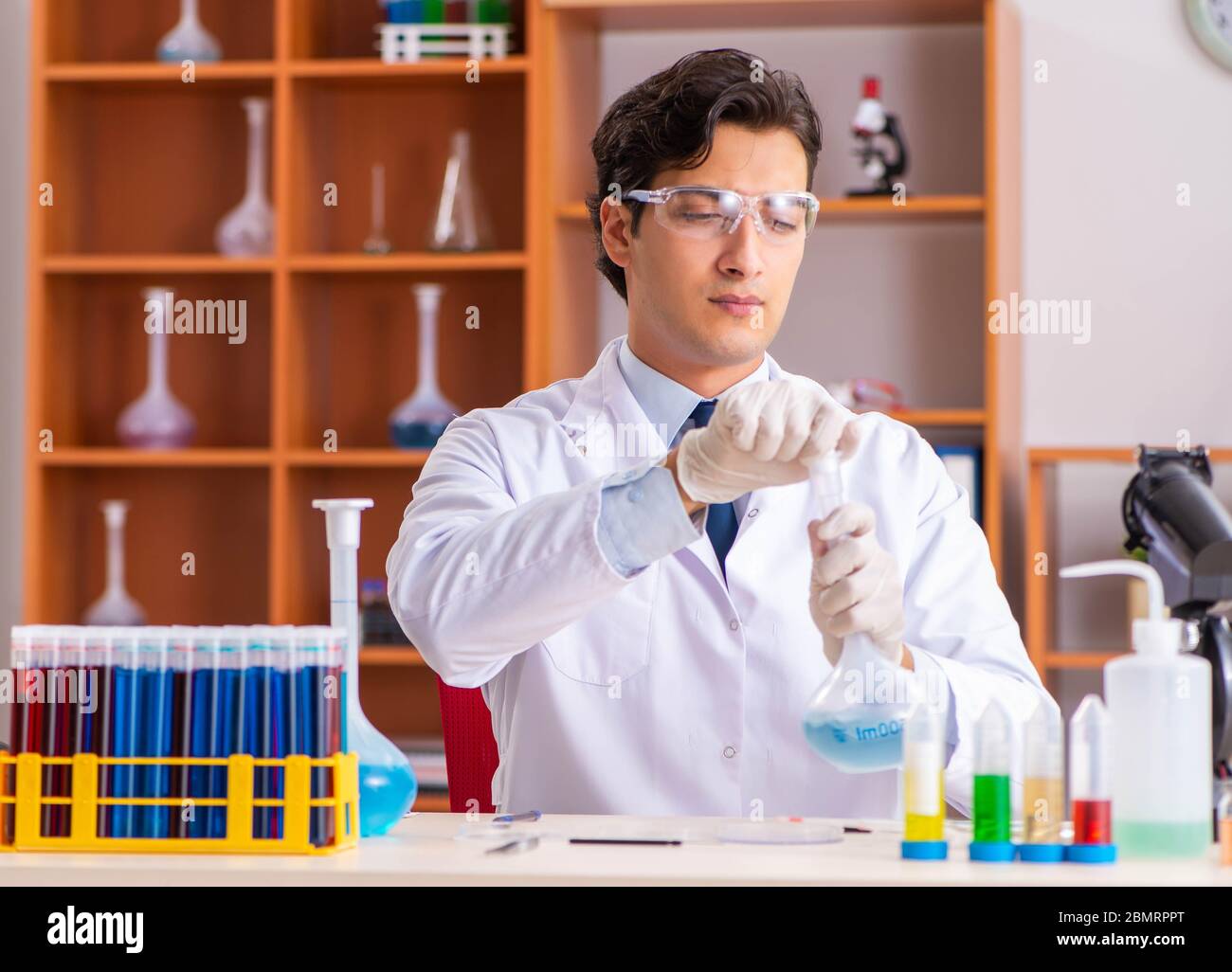 The young handsome biochemist working in the lab Stock Photo - Alamy