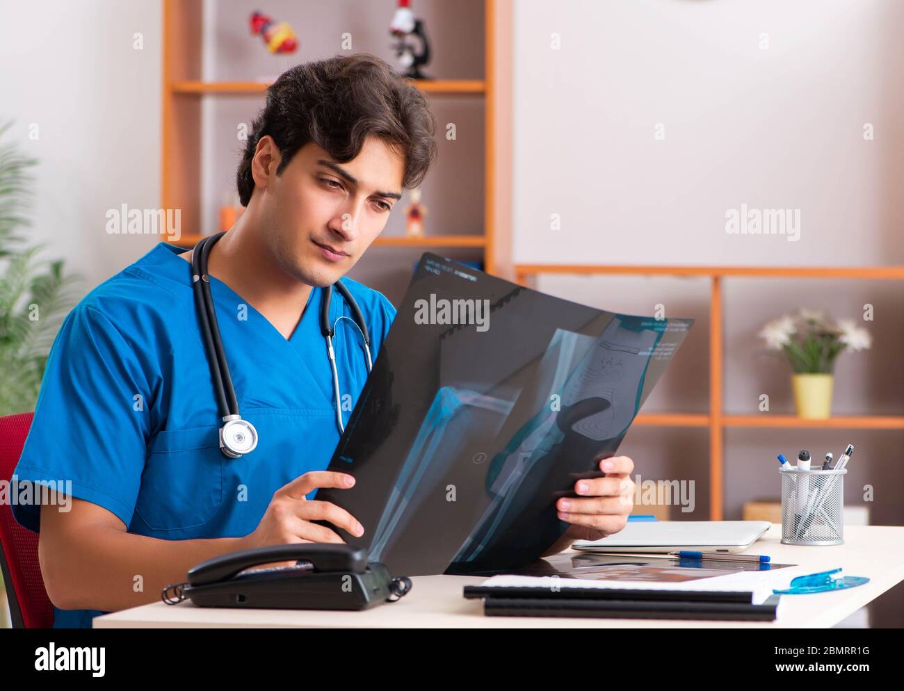 The young handsome doctor radiologyst working in clinic Stock Photo - Alamy