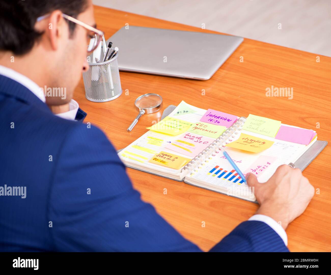 The young handsome employee planning his work activity Stock Photo - Alamy