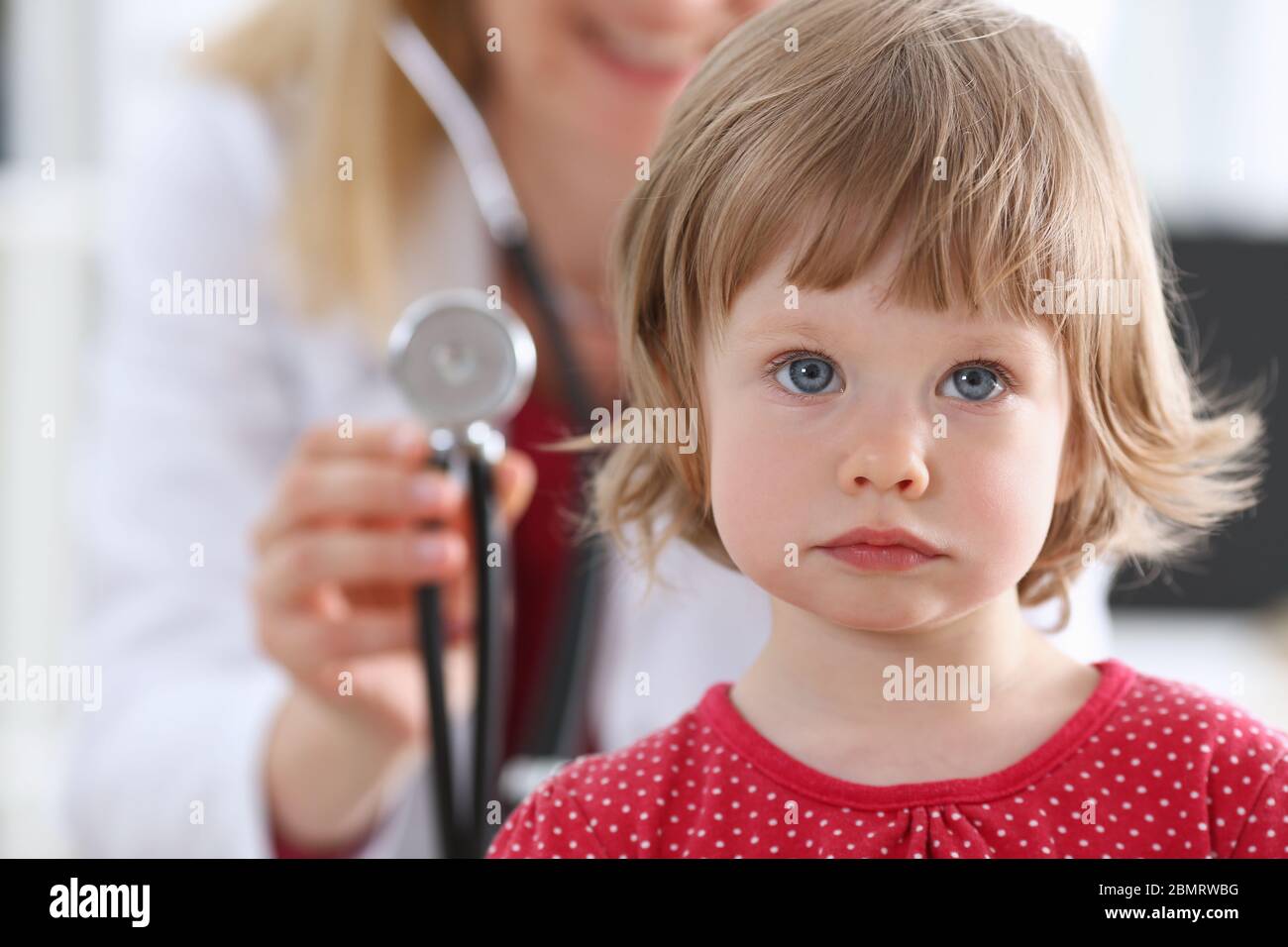 Little child with stethoscope at doctor reception Stock Photo - Alamy