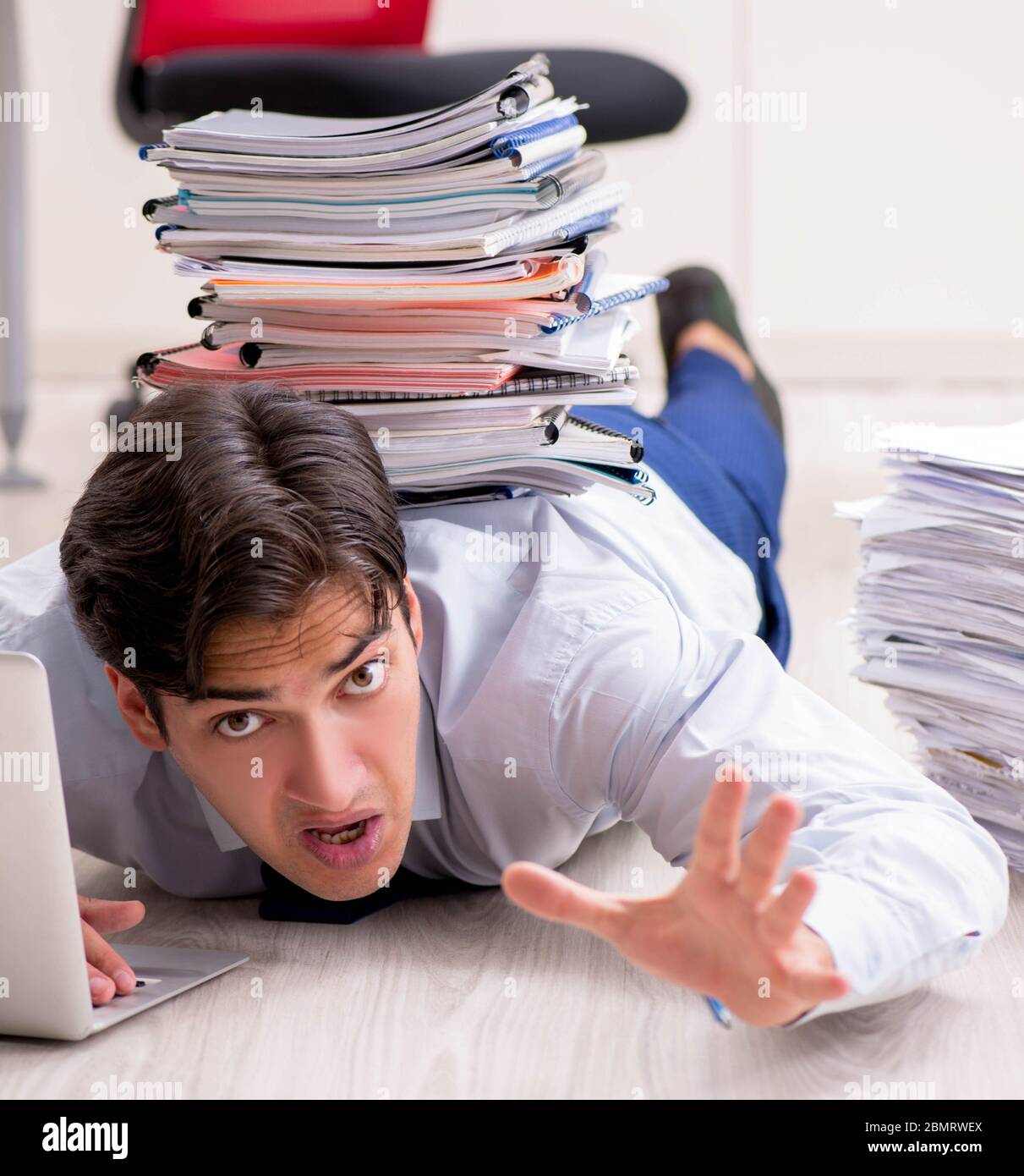 The extremely busy employee working in the office Stock Photo - Alamy