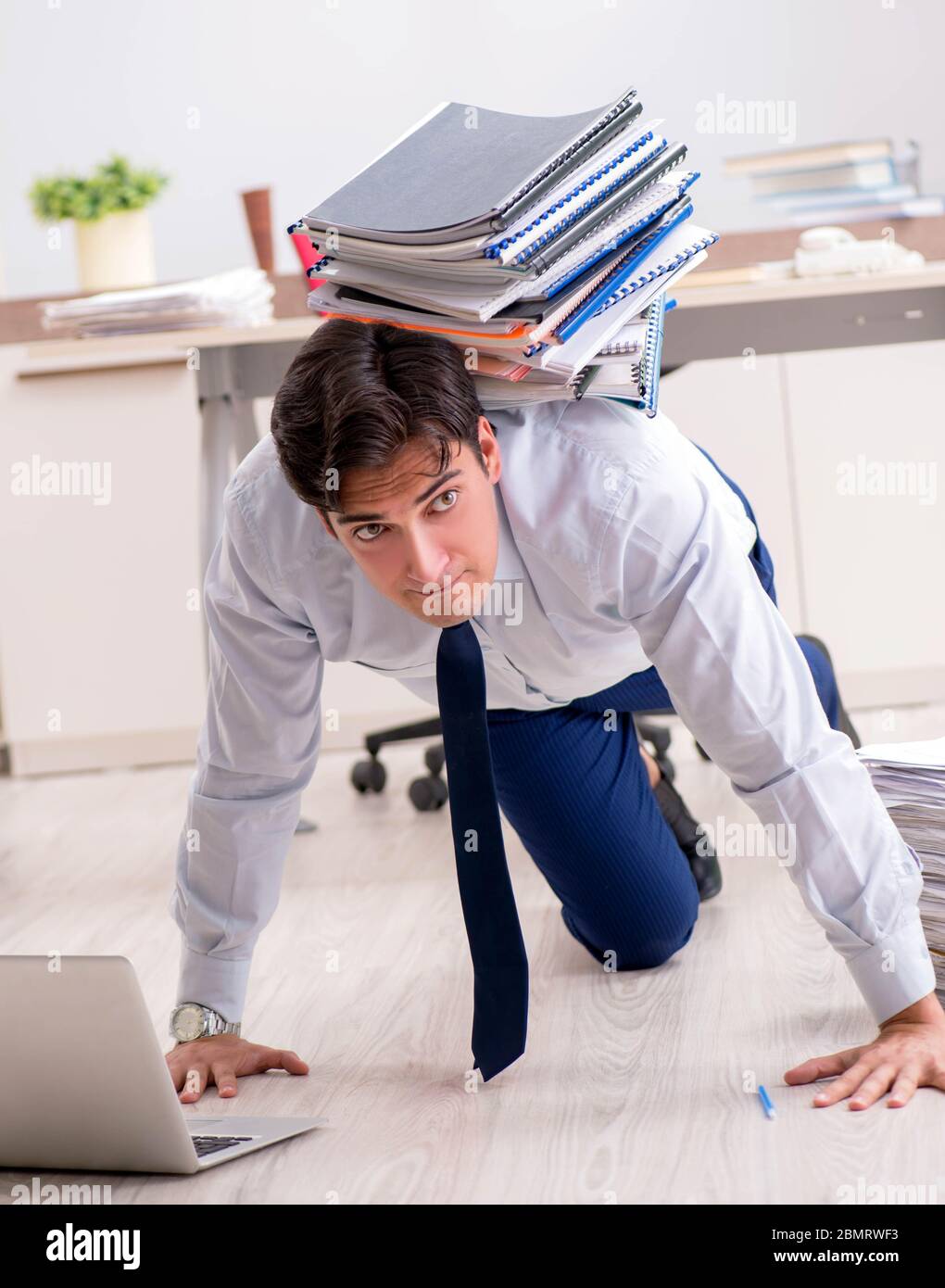 The extremely busy employee working in the office Stock Photo - Alamy