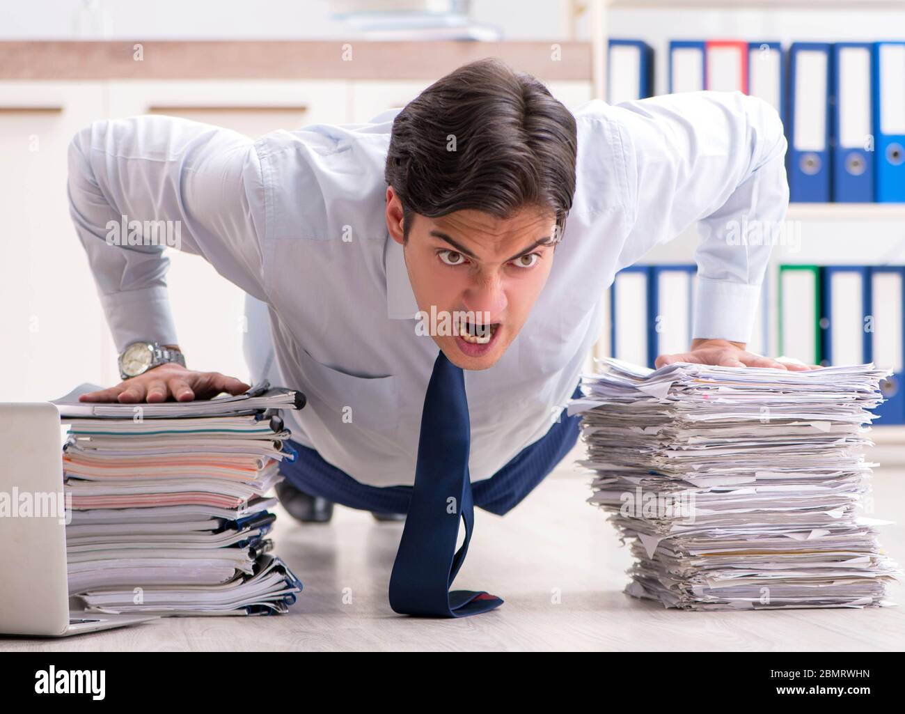 The extremely busy employee working in the office Stock Photo - Alamy