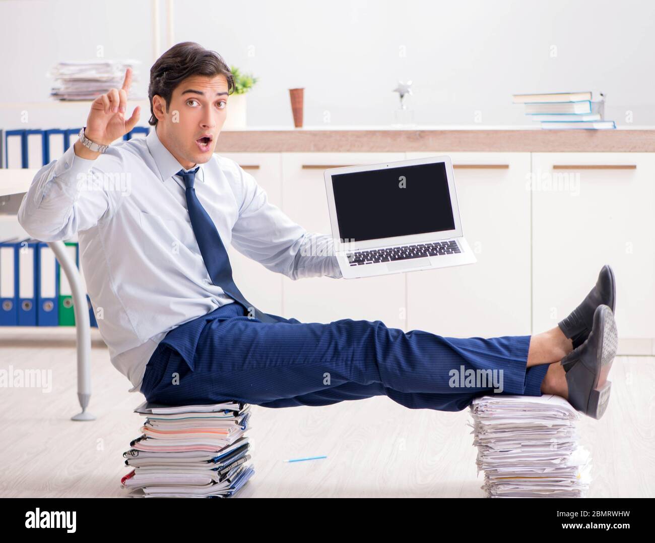 The extremely busy employee working in the office Stock Photo - Alamy