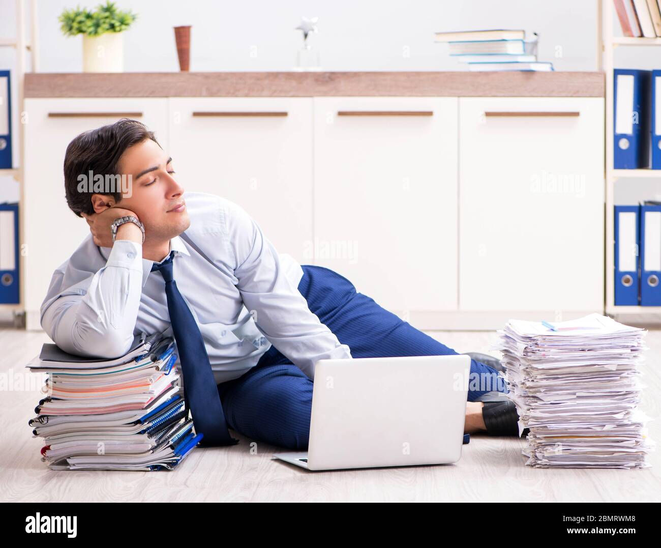 The extremely busy employee working in the office Stock Photo - Alamy