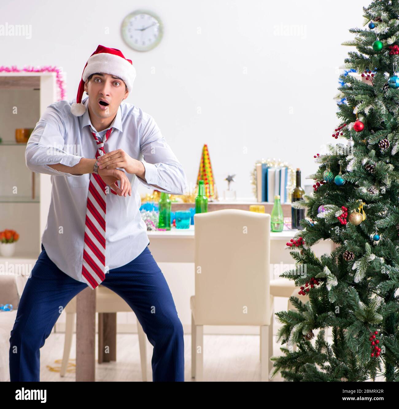 The young handsome employee celebrating christmas at workplace Stock ...