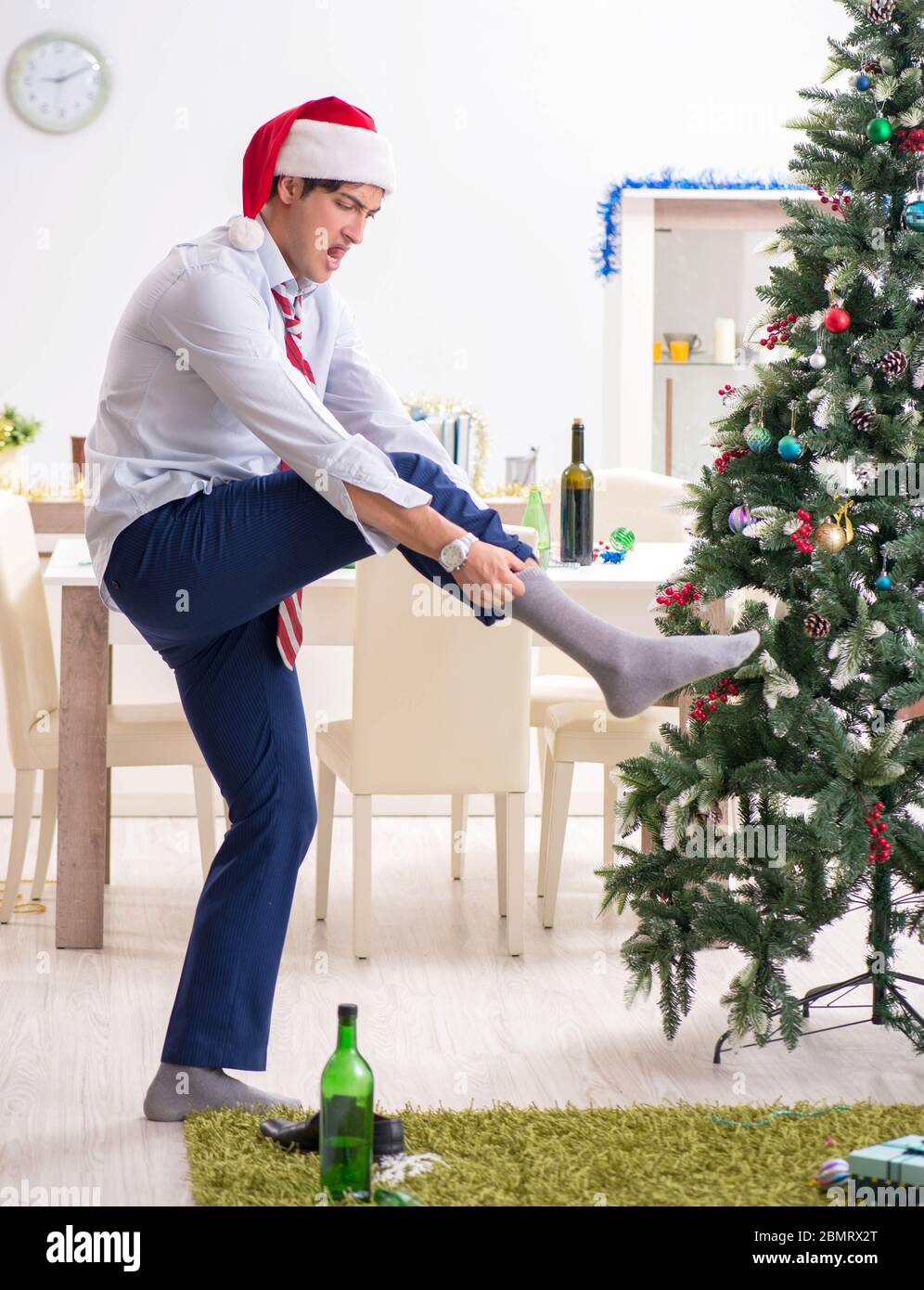 The young handsome employee celebrating christmas at workplace Stock ...