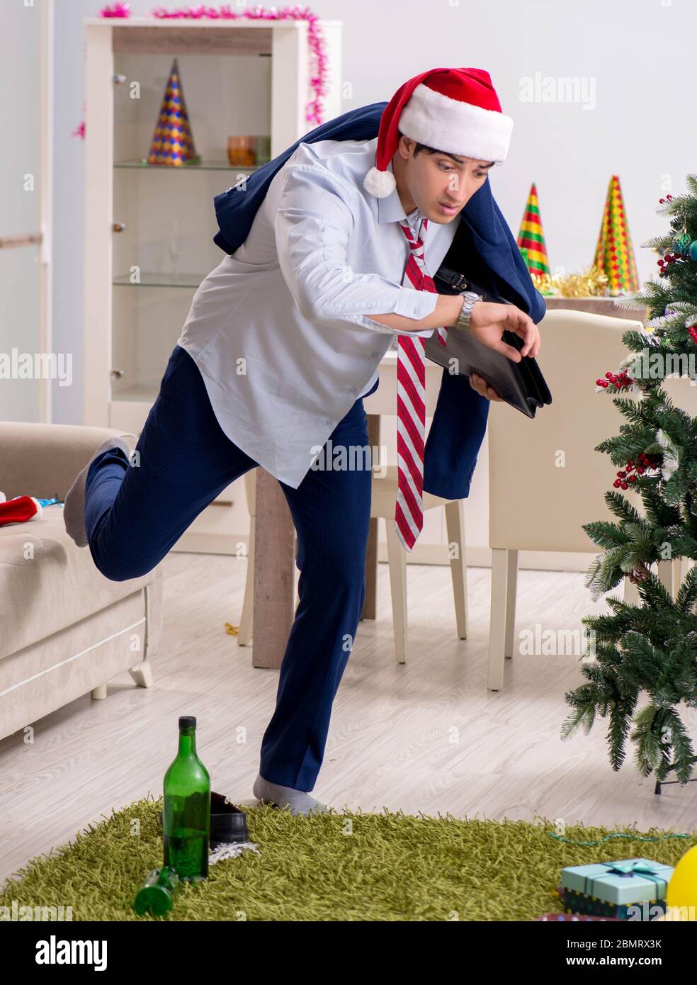 The young handsome employee celebrating christmas at workplace Stock ...