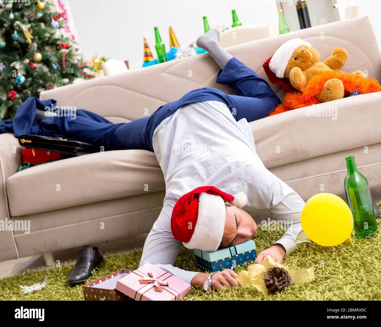 The young handsome employee celebrating christmas at workplace Stock ...