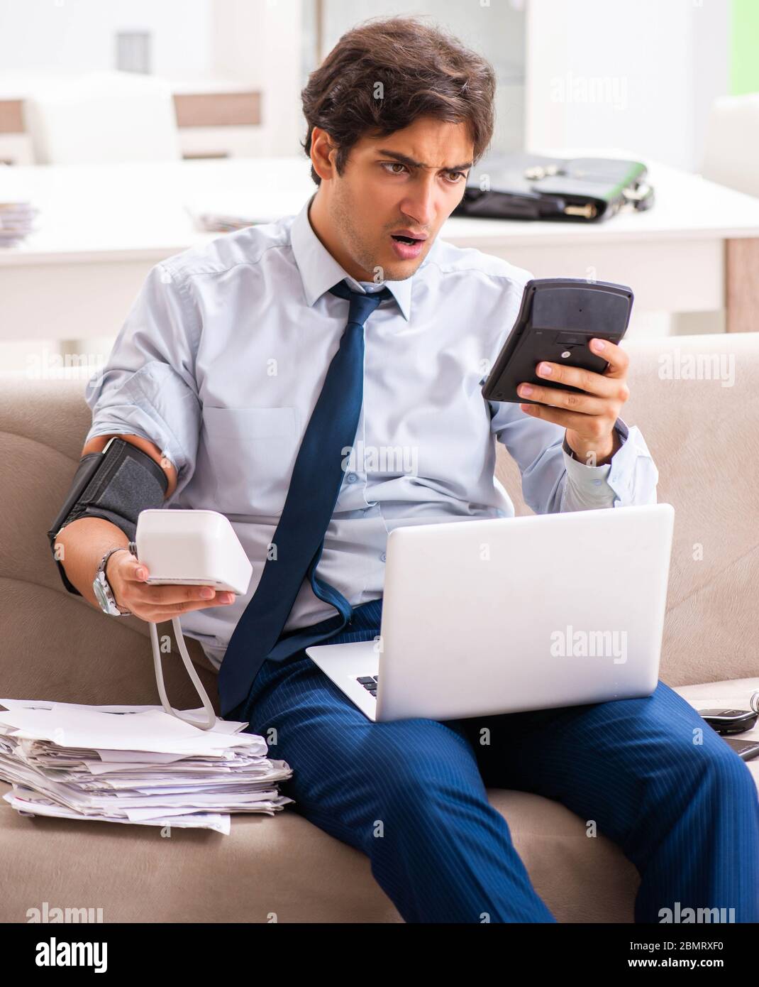 The man under stress measuring his blood pressure Stock Photo - Alamy