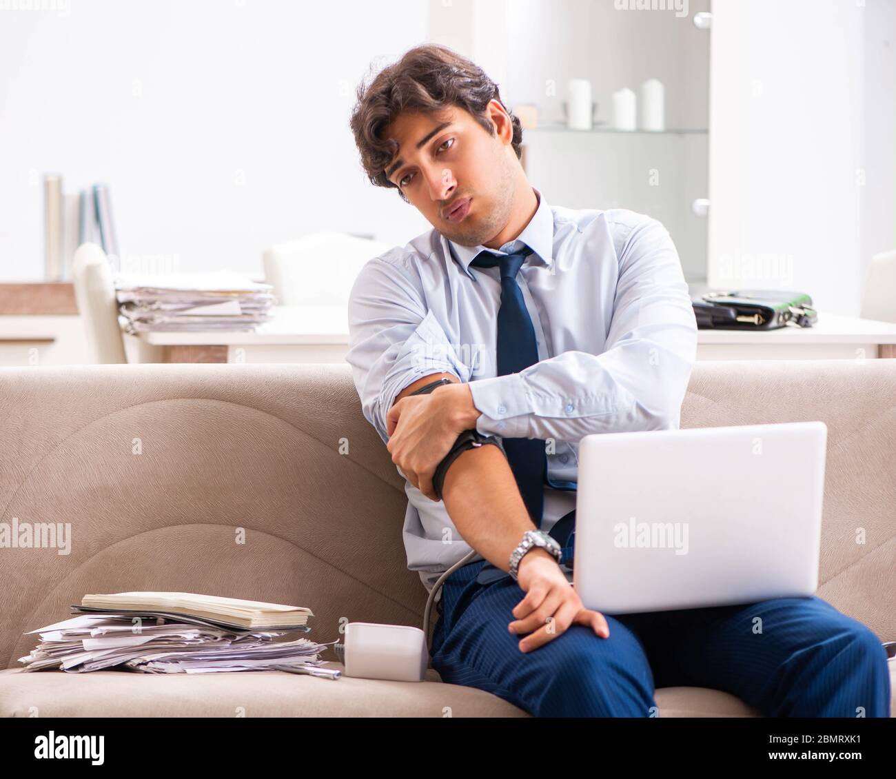 The man under stress measuring his blood pressure Stock Photo - Alamy