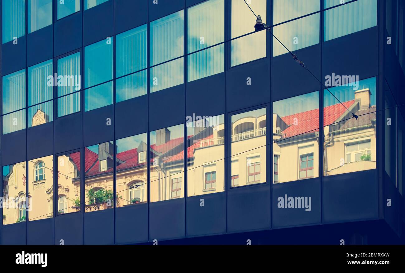 Old building architecture reflected in modern building. Front view of ...