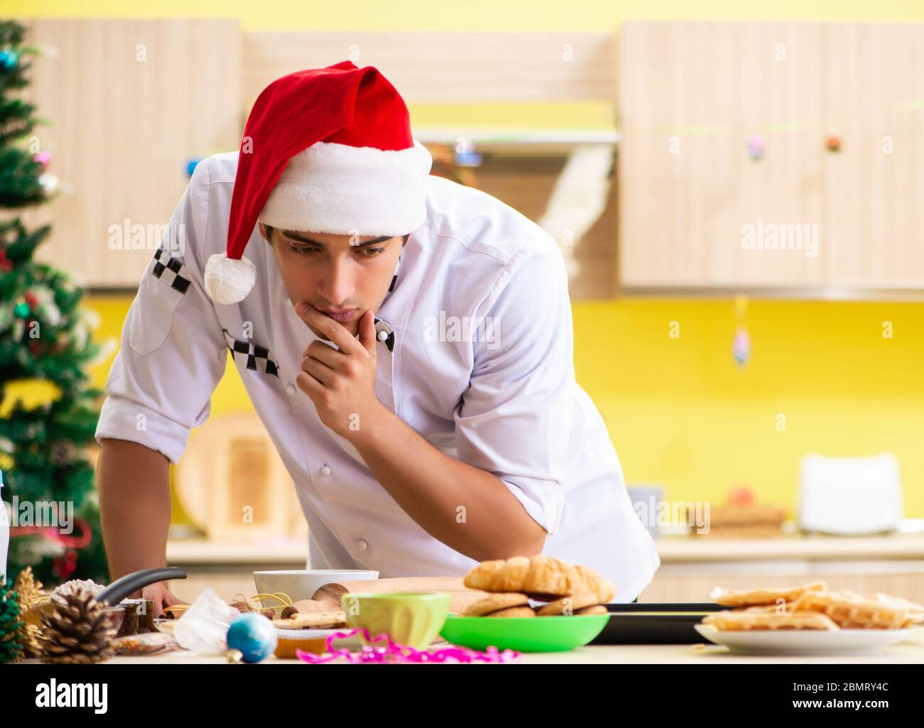 The young chef husband working in kitchen at christmas eve Stock Photo ...