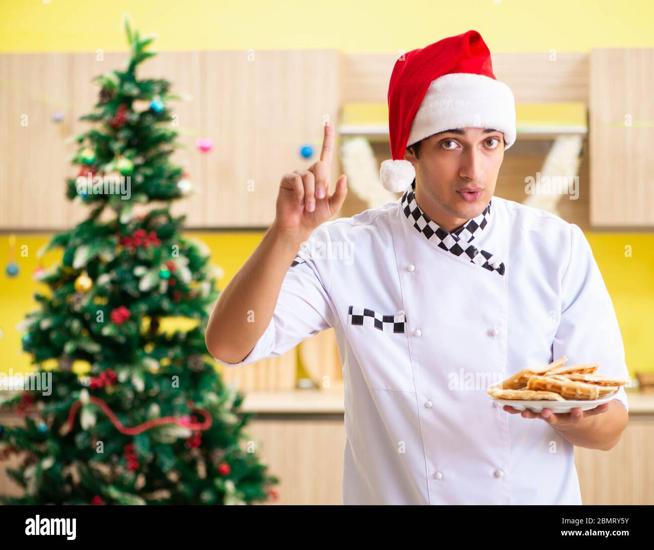 The young chef husband working in kitchen at christmas eve Stock Photo ...