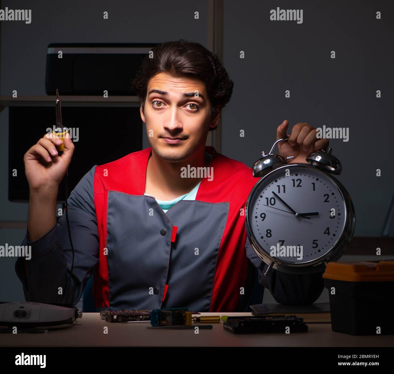 The young handsome repairman repairing computer Stock Photo - Alamy