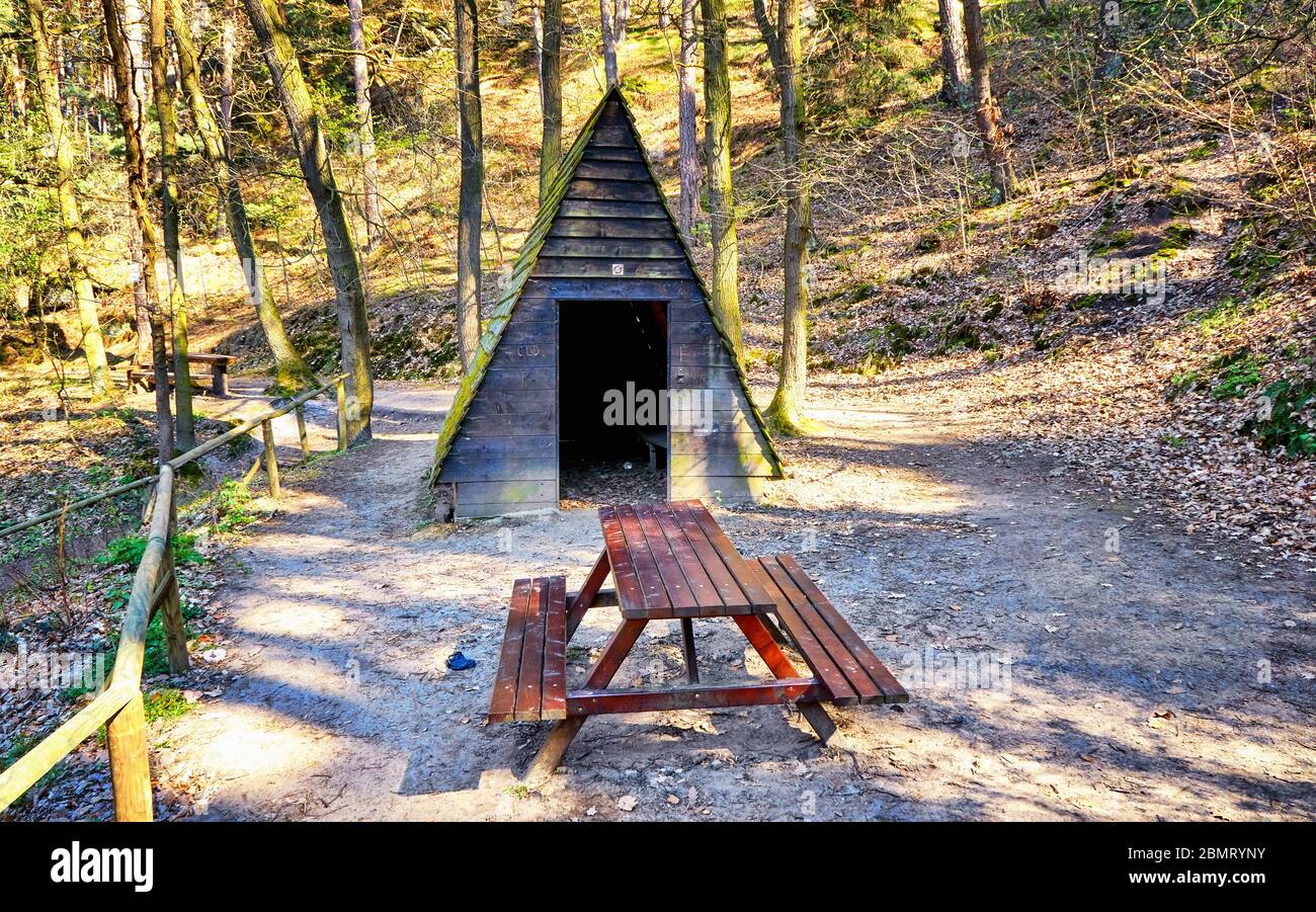 Resting place with wooden house and picnic table and bench in the ...