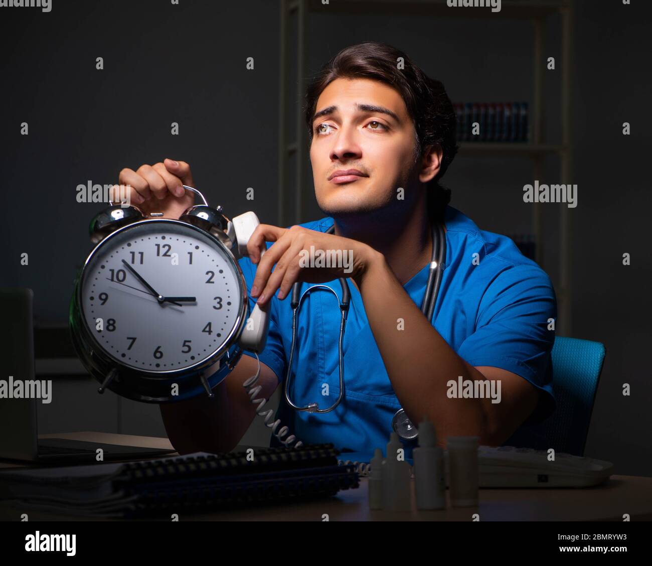 The young handsome doctor working night shift in hospital Stock Photo ...