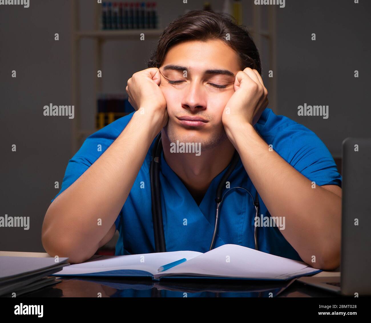 The young handsome doctor working night shift in hospital Stock Photo ...