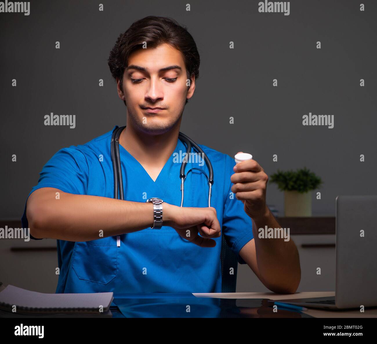 The young handsome doctor working night shift in hospital Stock Photo ...