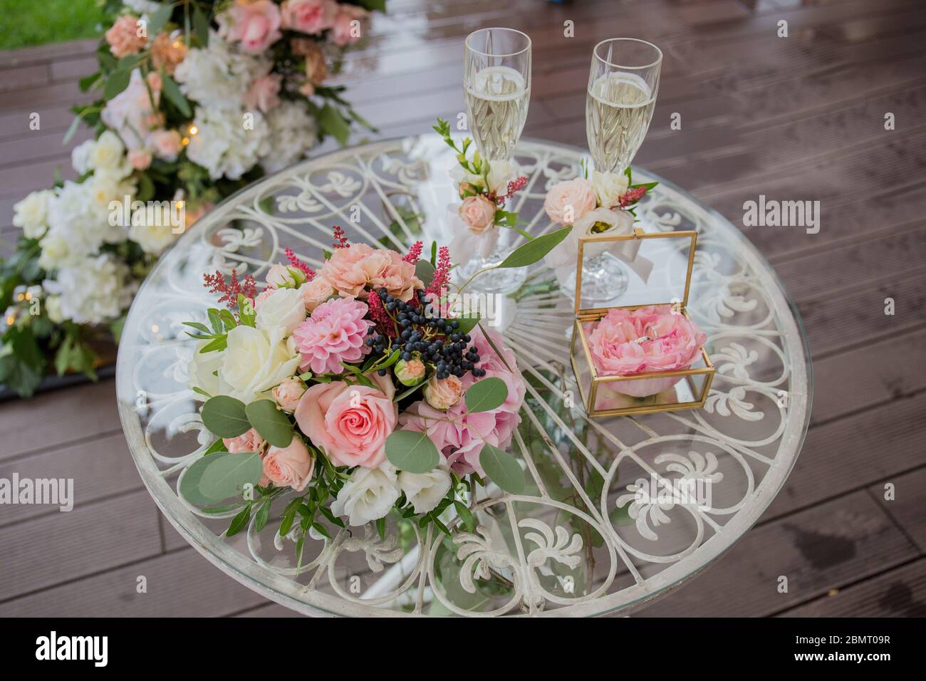 champagne and rings on arch table for ceremony Stock Photo - Alamy