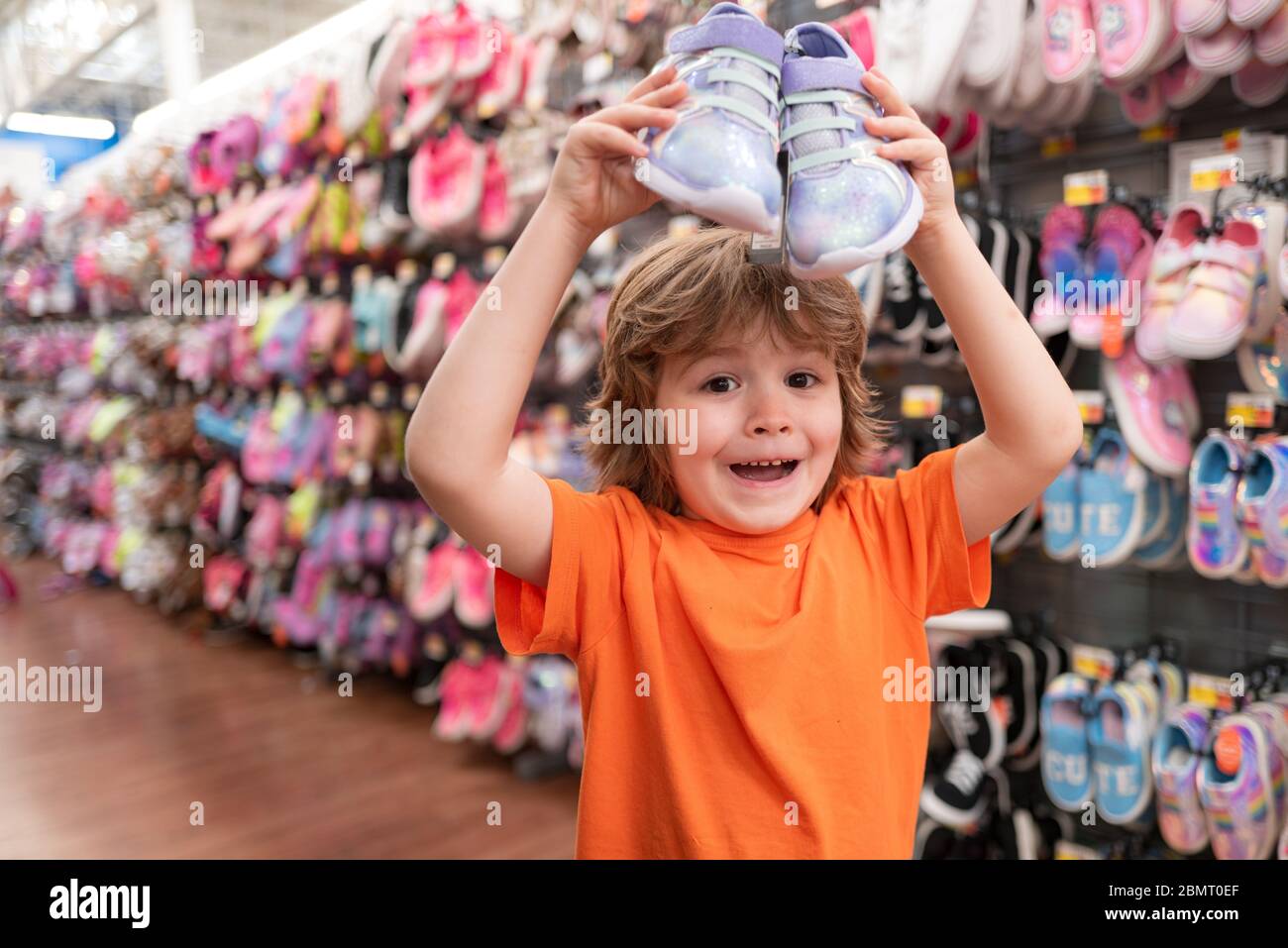 Sale, consumerism and people concept. Kids shoes store in supermarket ...