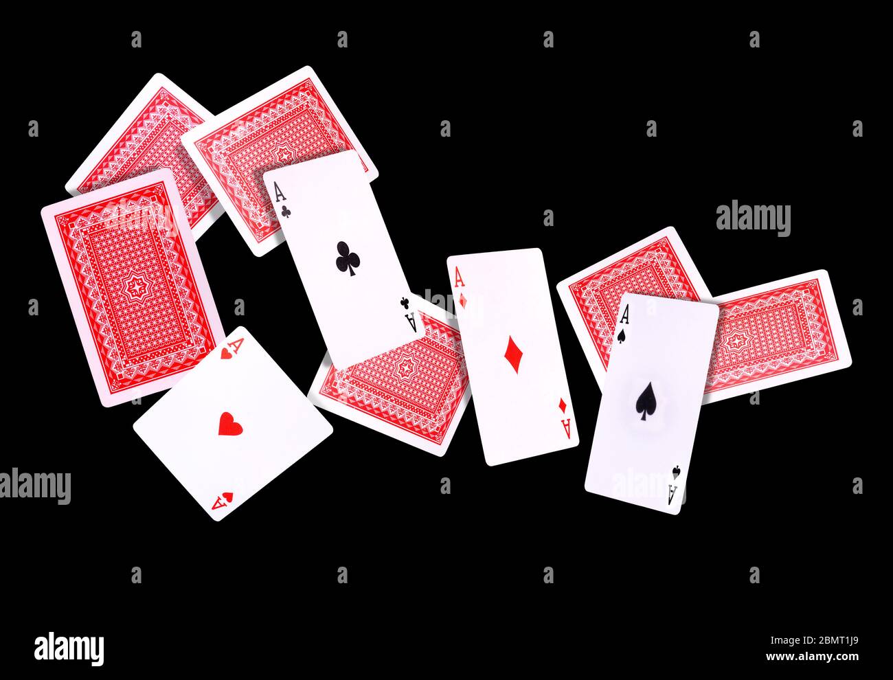Flying playing cards for poker game on black background Stock Photo - Alamy