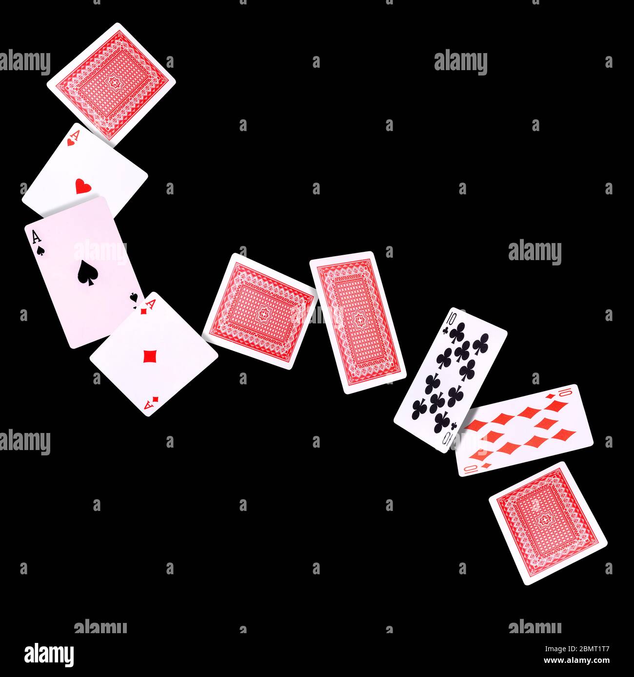 Flying playing cards for poker game on black background Stock Photo - Alamy