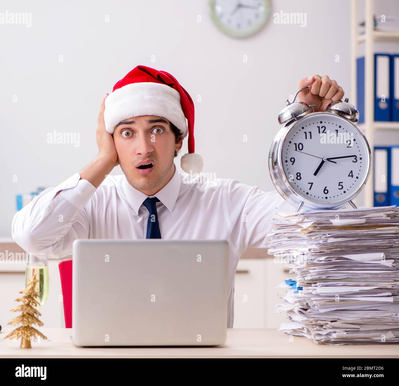 The young worker working in office on christmas shift Stock Photo - Alamy