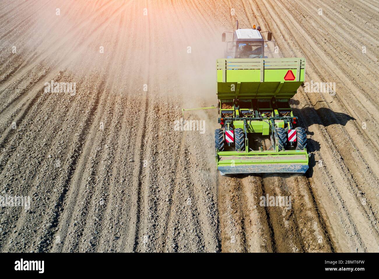 tractor in the field planting potatoes in the fertile farm fields Stock ...