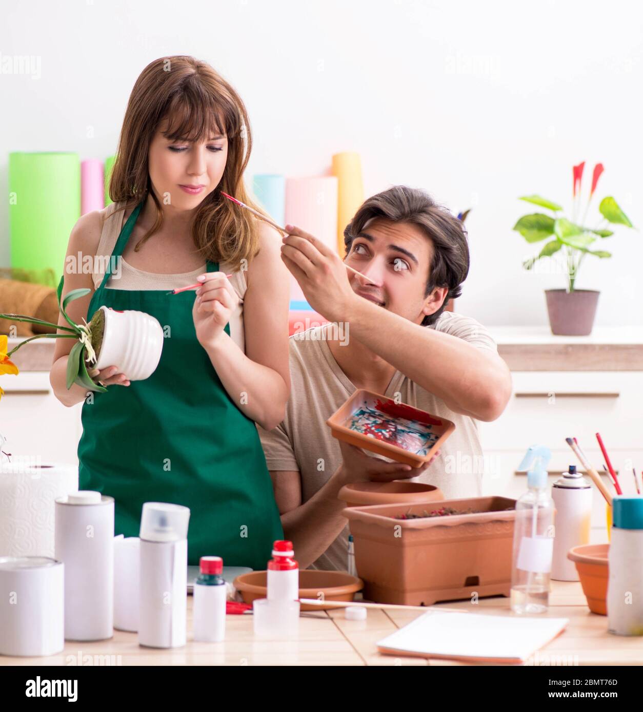 The couple decorating pots in workshop during class Stock Photo - Alamy