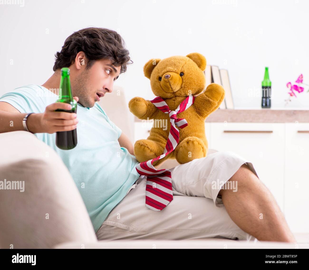 The young drunk handsome man after party at home Stock Photo - Alamy