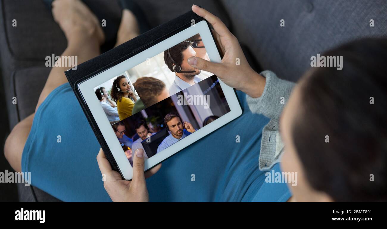 Woman having video call with people working on laptop Stock Photo - Alamy