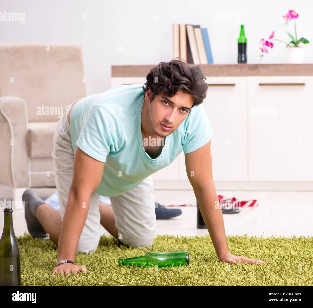 The young drunk handsome man after party at home Stock Photo - Alamy