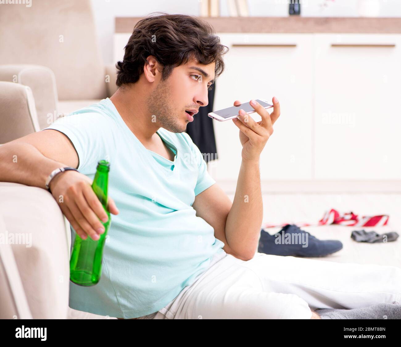 The young drunk handsome man after party at home Stock Photo - Alamy
